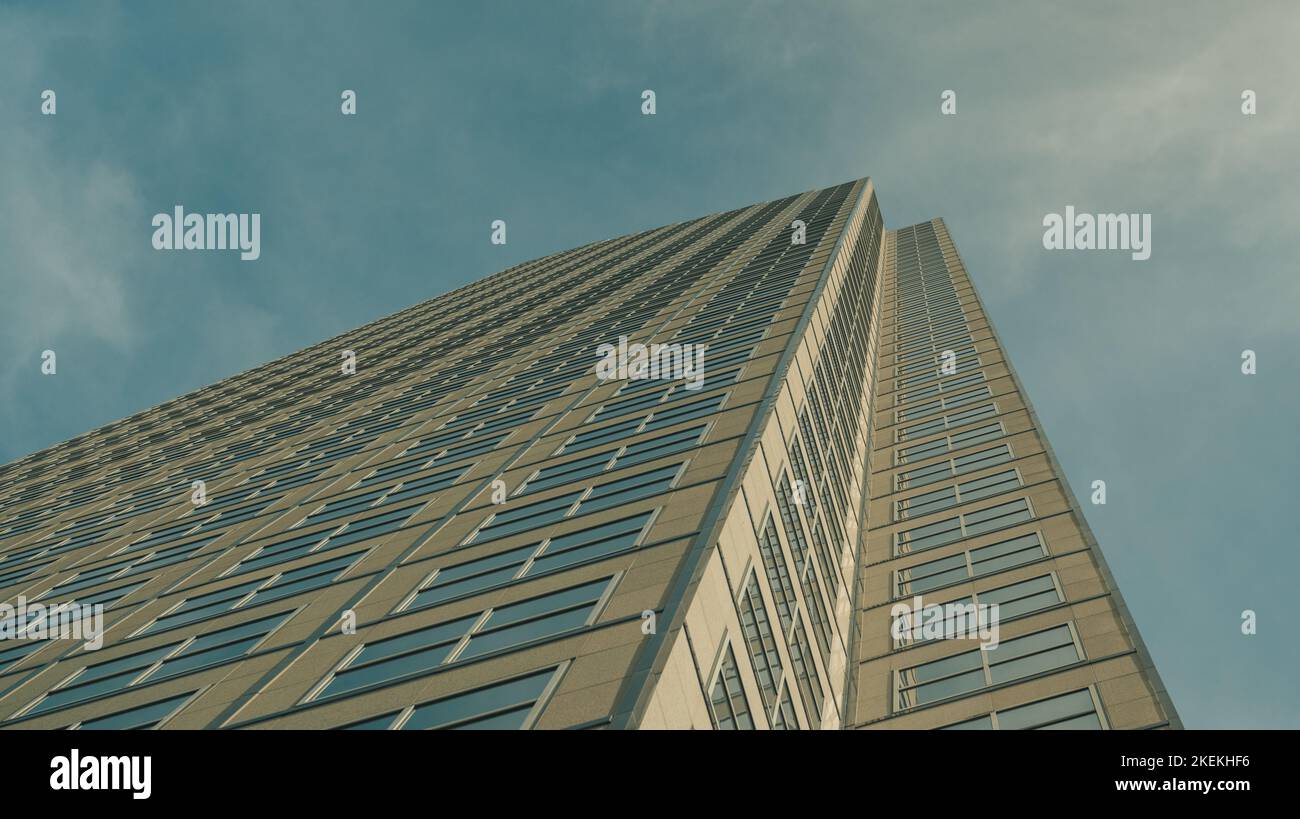 A low angle shot of a modern residential building against a blue sky ...