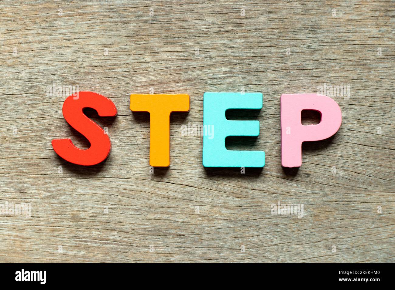 Color alphabet letter in word step on wood background Stock Photo - Alamy