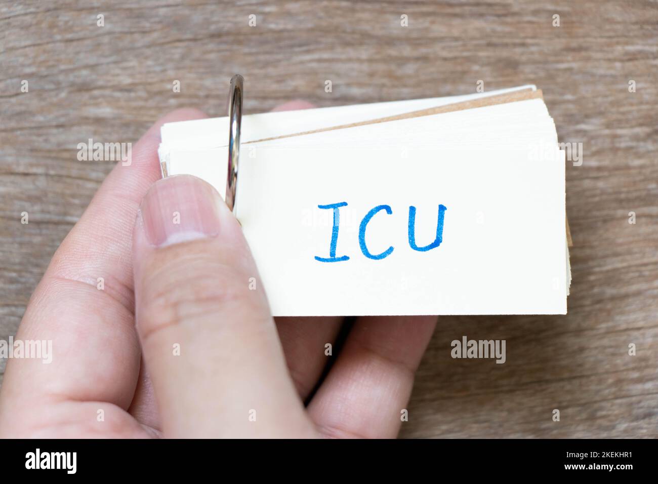Hand hold flash card with handwriting in word ICU (abbreviation of ...