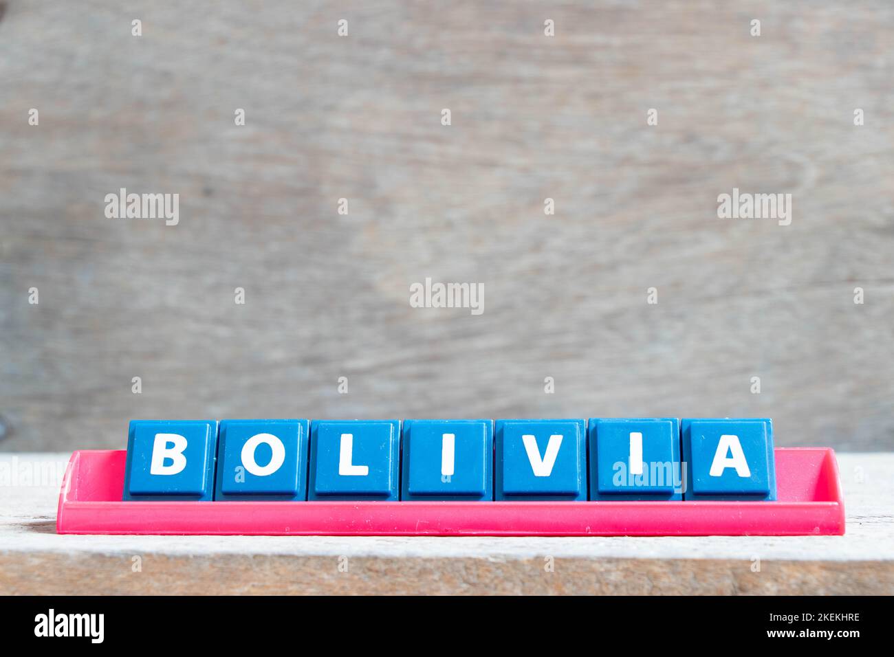 Tile alphabet letter with word bolivia in red color rack on wood ...