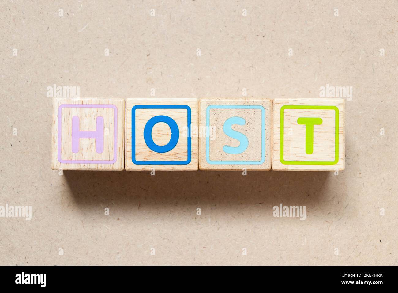 Color letter block in word host on wood background Stock Photo - Alamy