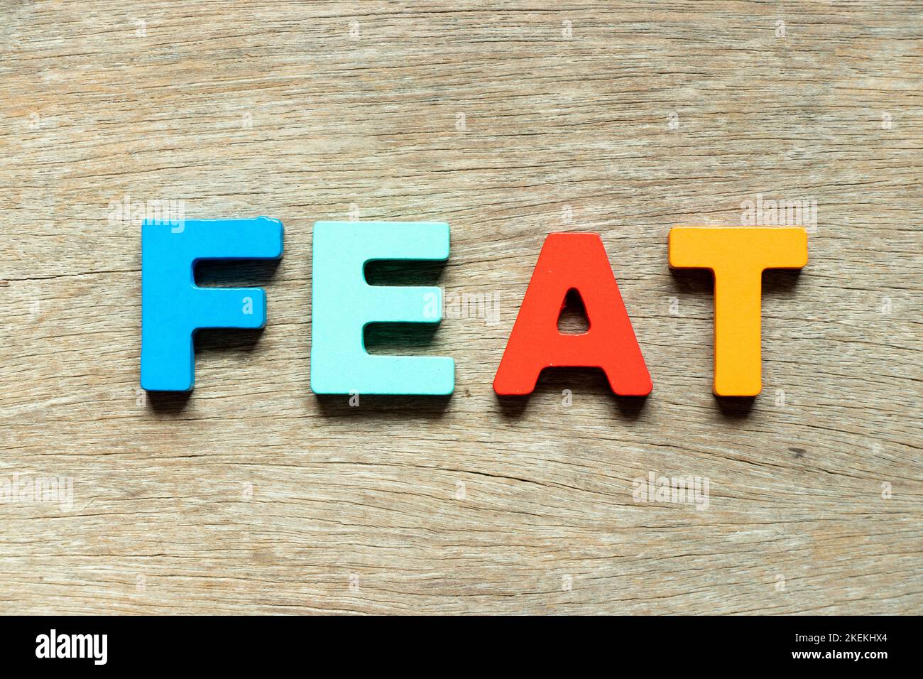 Color alphabet letter in word feat on wood background Stock Photo - Alamy