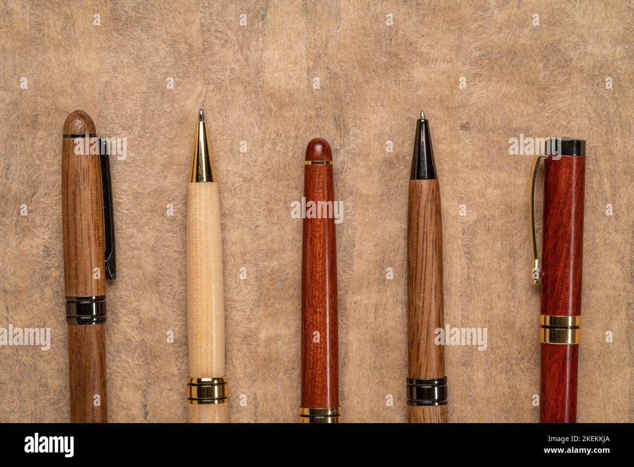 collection of stylish wooden pens - flat lay on handmade bark paper ...