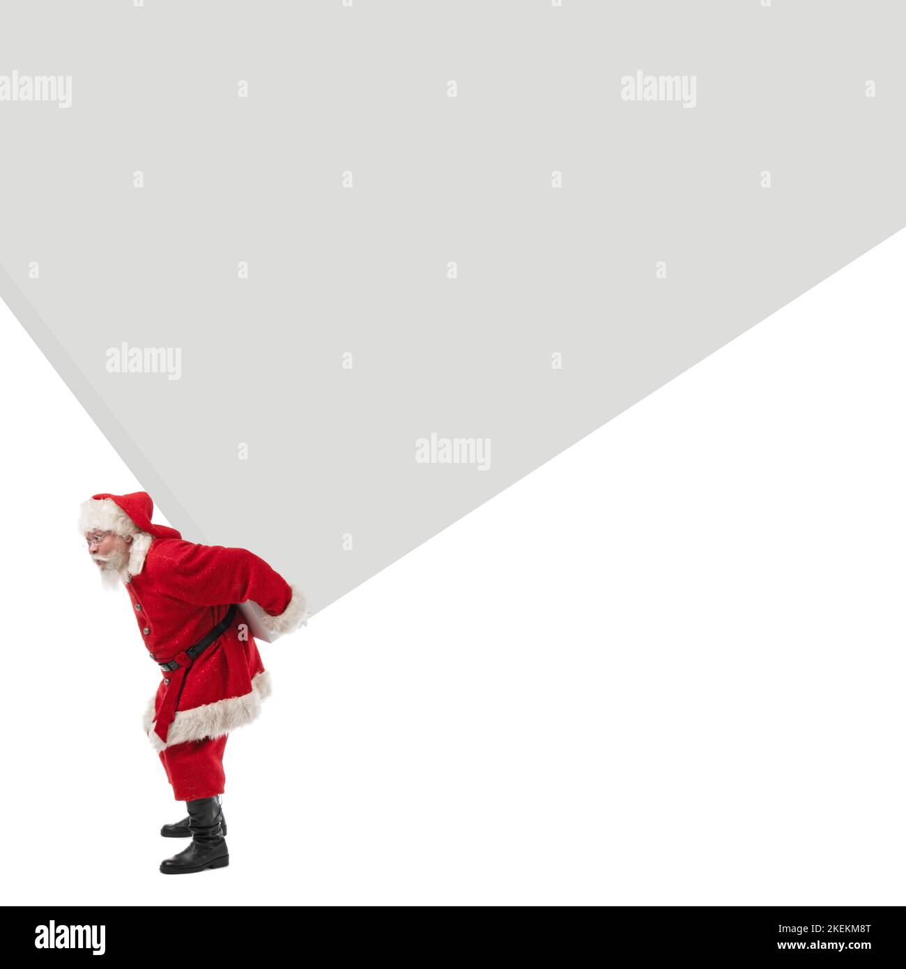Santa Claus holding big heavy banner isolated on white background with ...