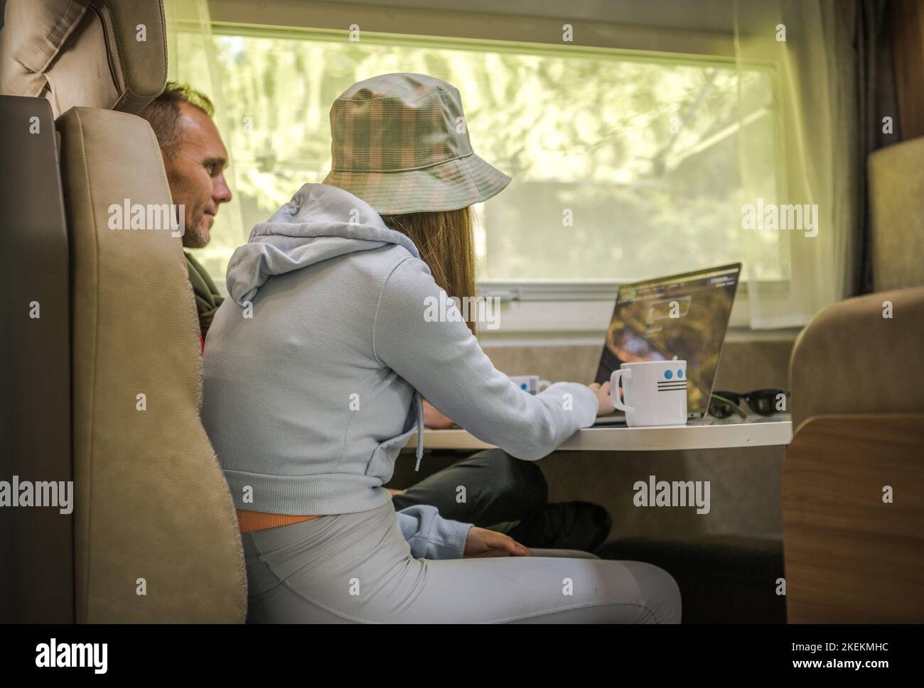 Father and His Daughter Playing on a Laptop Inside Their Camper Van. RV ...