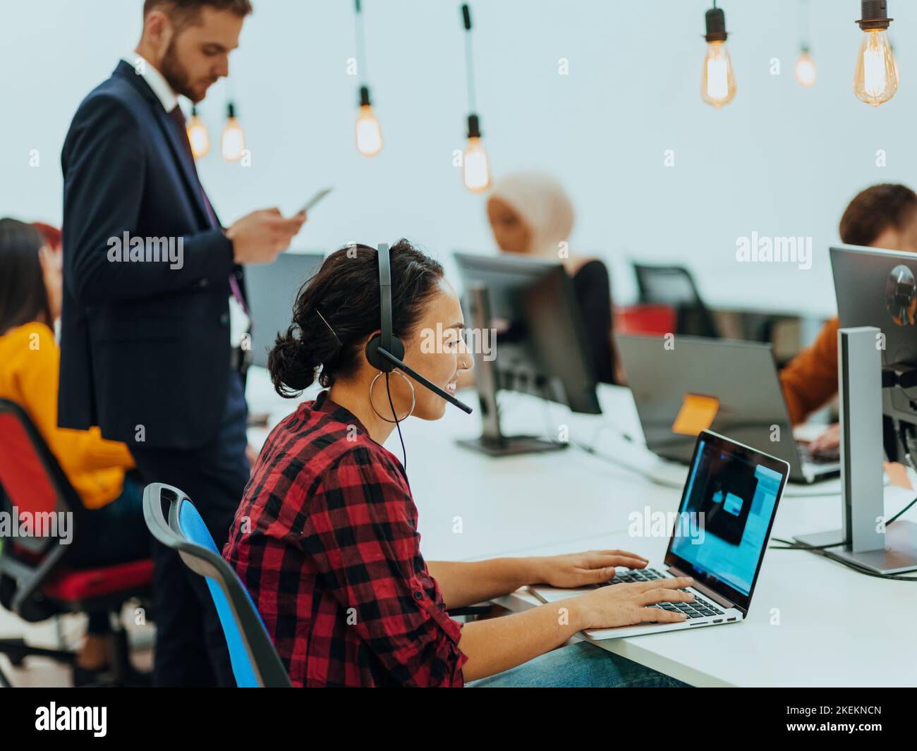 Group of multi-ethnic colleagues working on desktop computers, laptop ...
