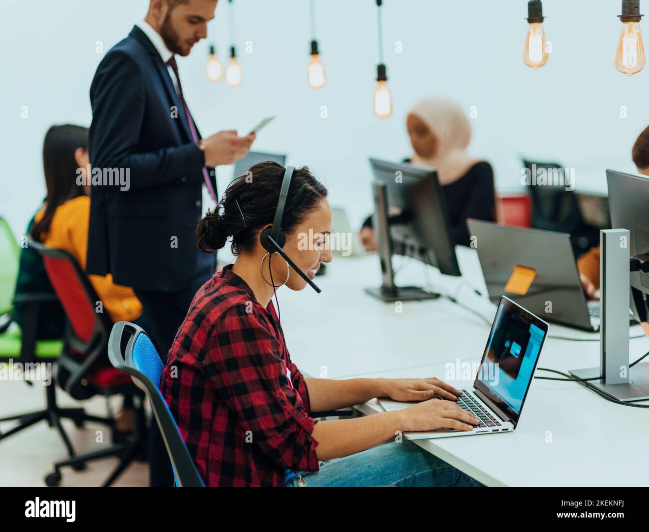 Group of multi-ethnic colleagues working on desktop computers, laptop ...