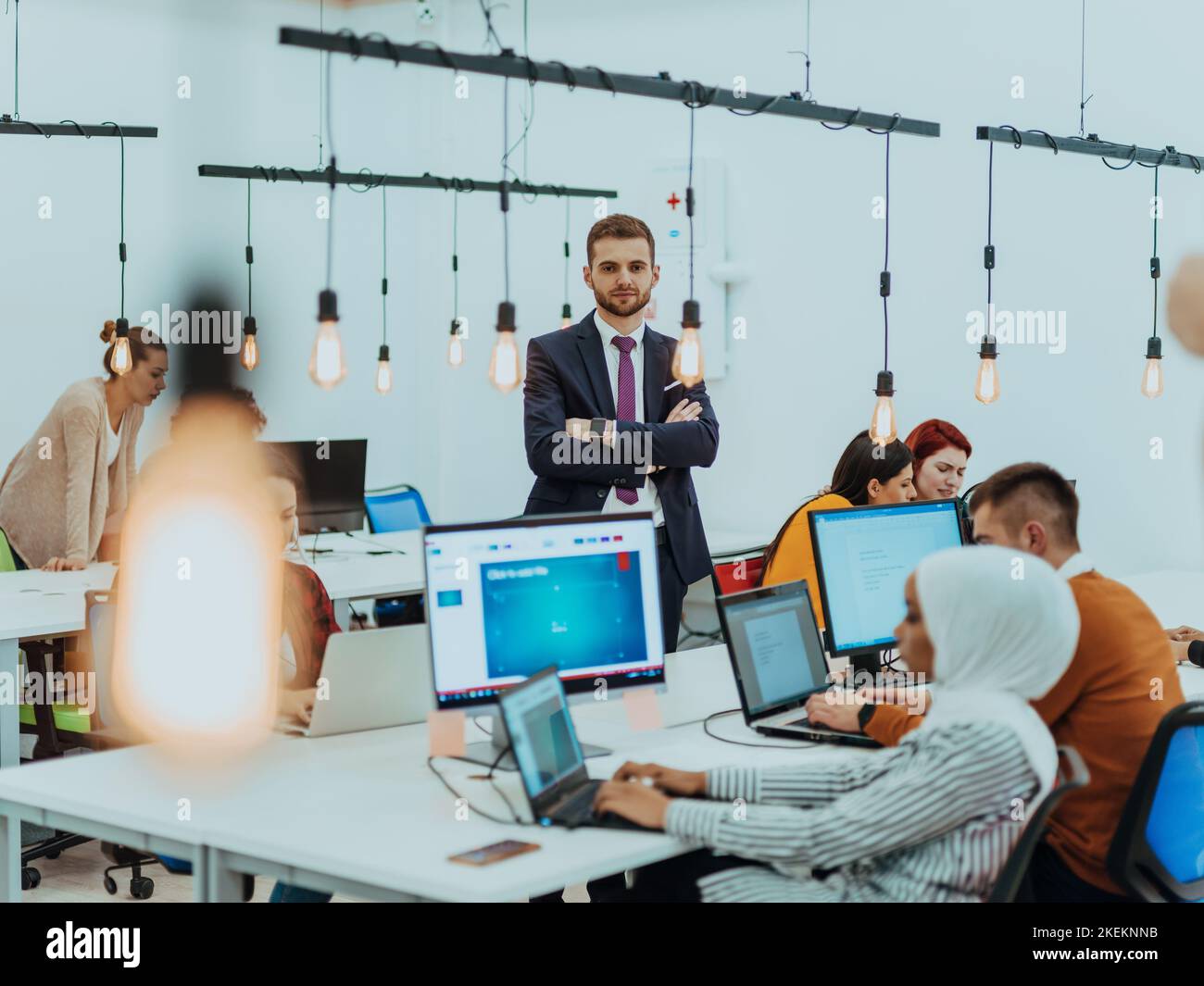 Group of multi-ethnic colleagues working on desktop computers, laptop ...