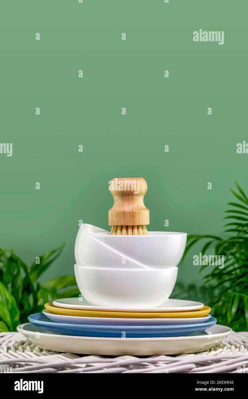 Eco-friendly dish washing. Zero waste lifestyle. Pile of ceramic plates ...