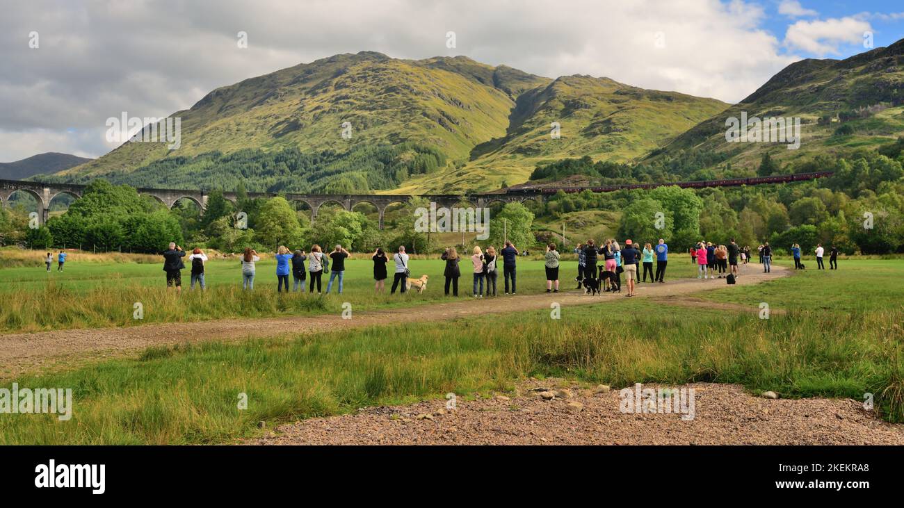 People watching and photographing The Jacobite steam train crossing ...