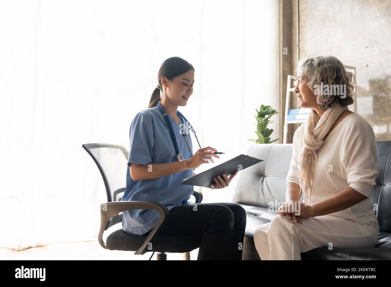 Happy patient is holding caregiver for a hand while spending time ...