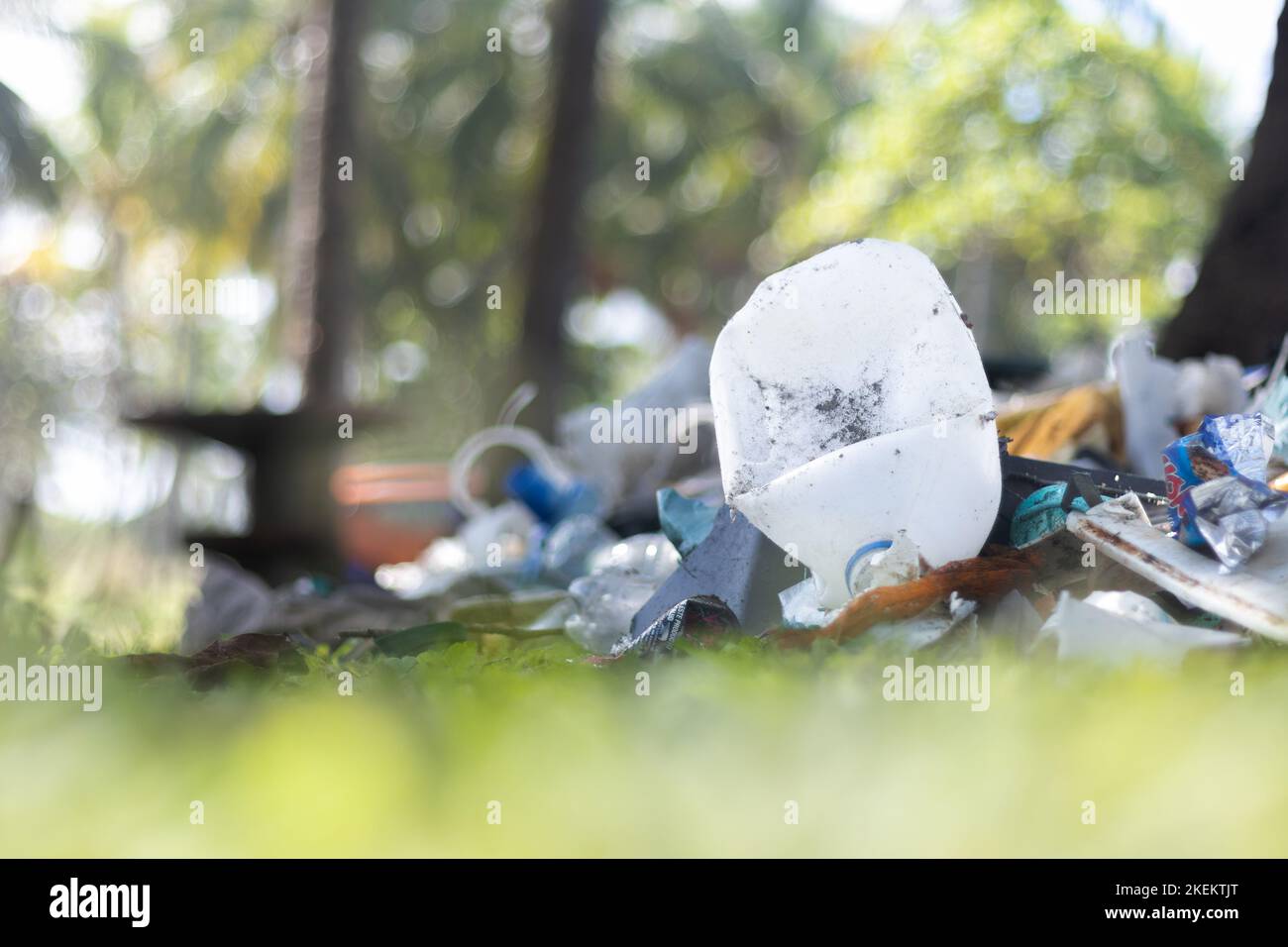 The view of a pile of garbage on the grass outdoors - land pollution ...