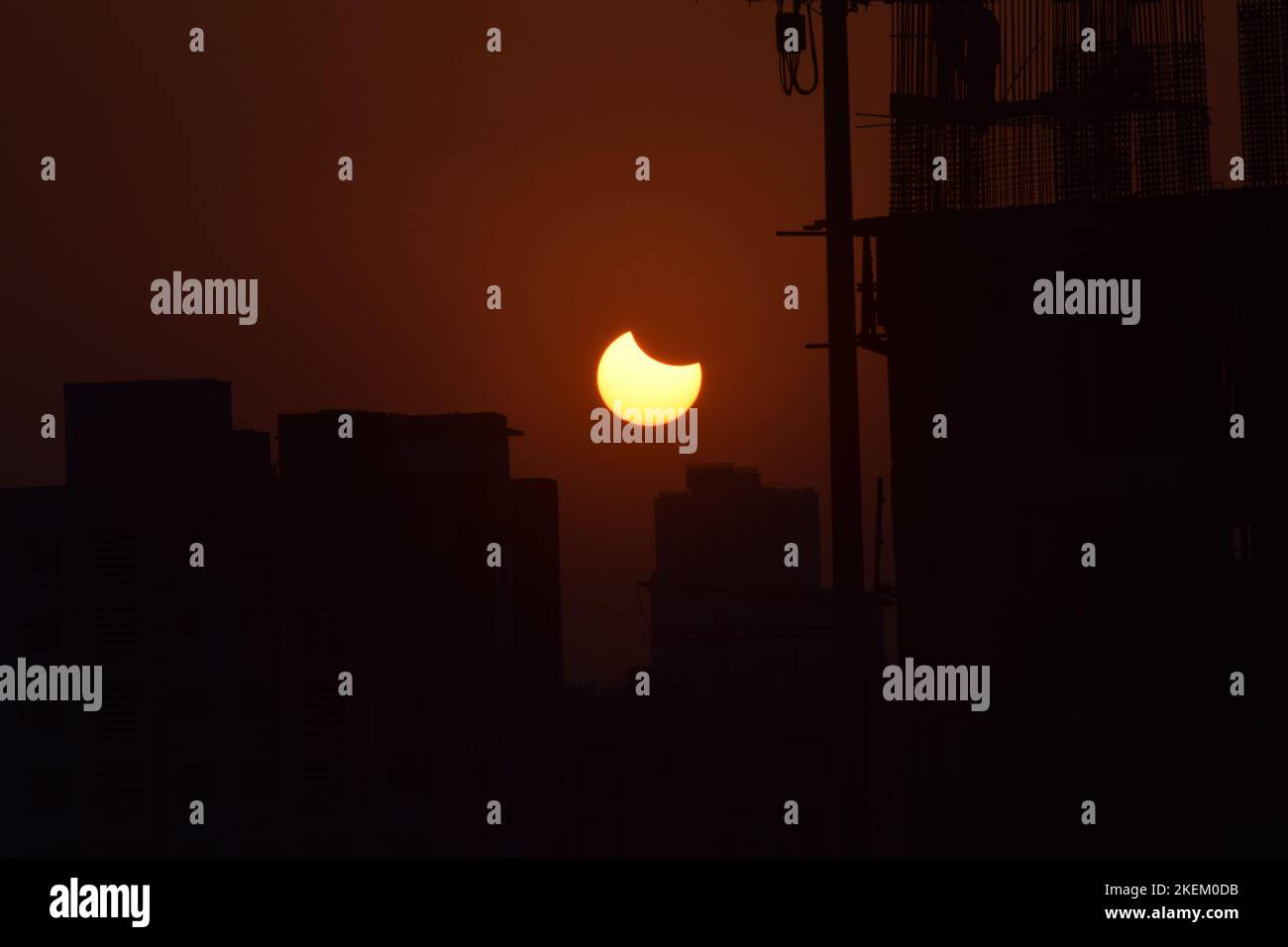 Partial Solar Eclipse during sunset with silhouettes of buildings Stock ...