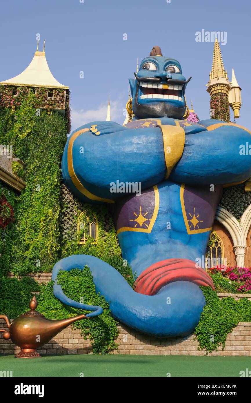 Huge blue smiling statue of genie with magic lamp in famous blossom ...