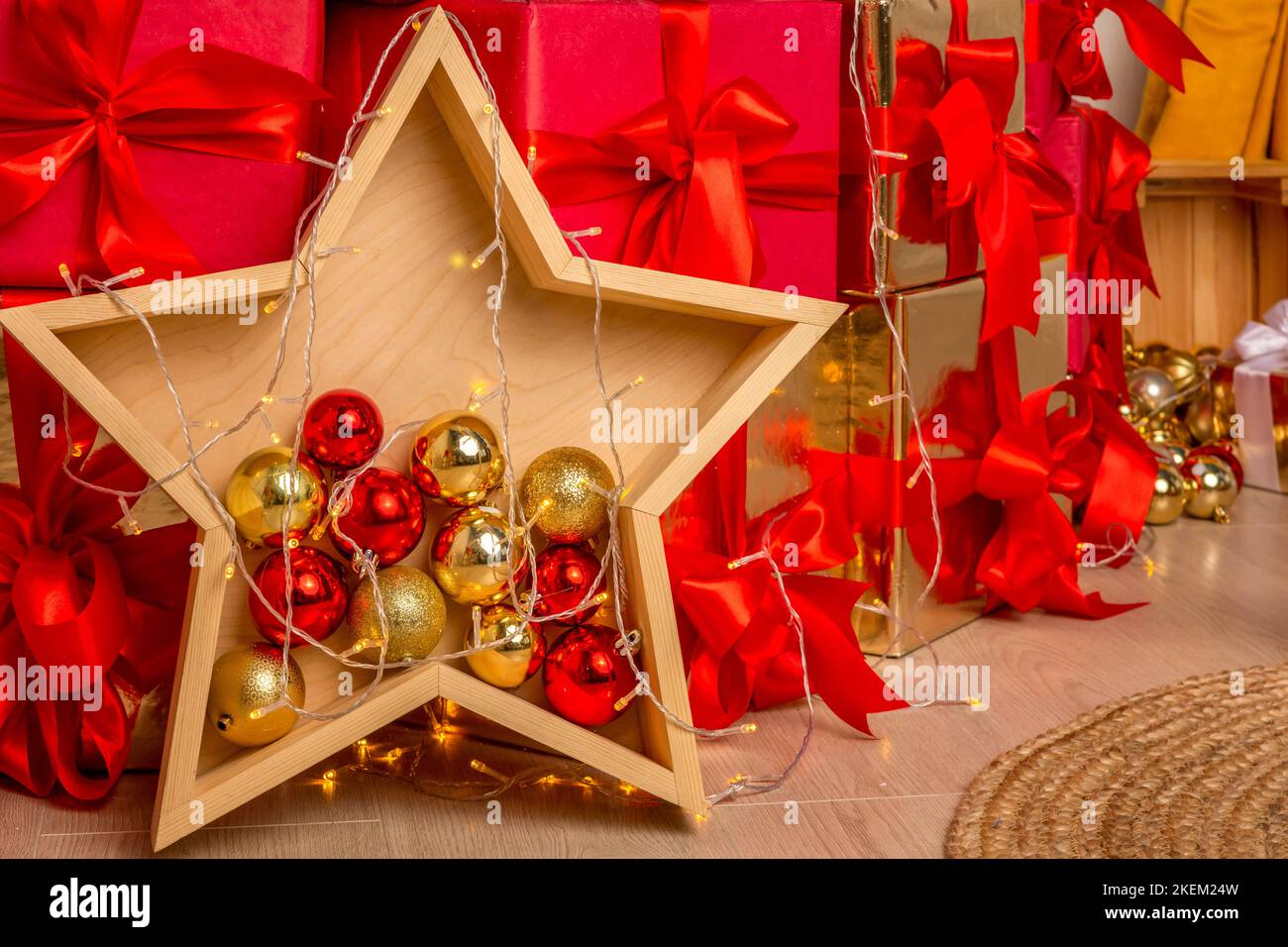 winter holiday interior, magic star with red balloons and packed gifts ...