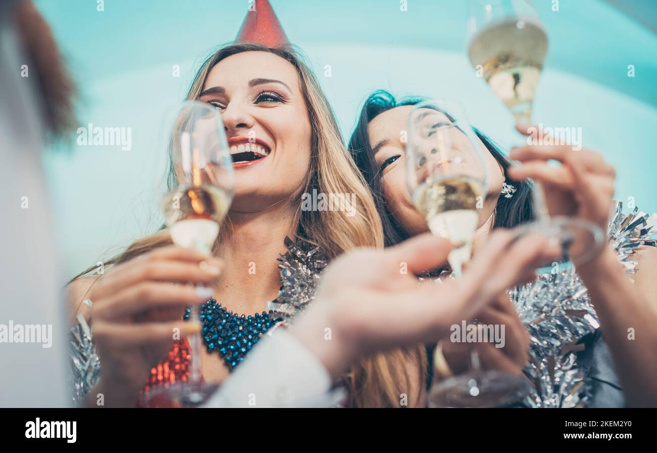 Group of friends in a bar toasting with champagne and celebrating Stock ...
