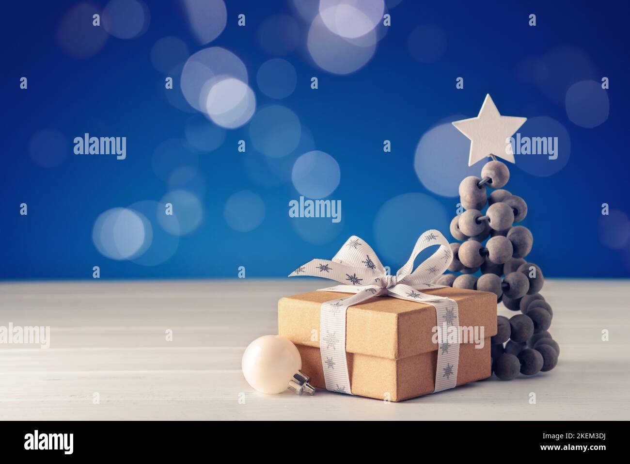 Gift box and Christmas tree on the table Stock Photo - Alamy