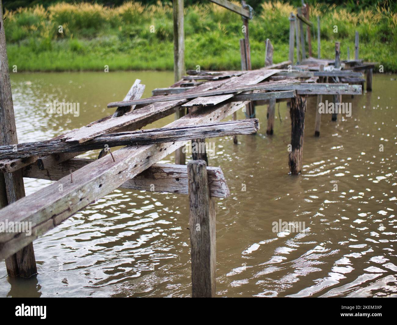 A broken wooden bridge across a river Stock Photo - Alamy