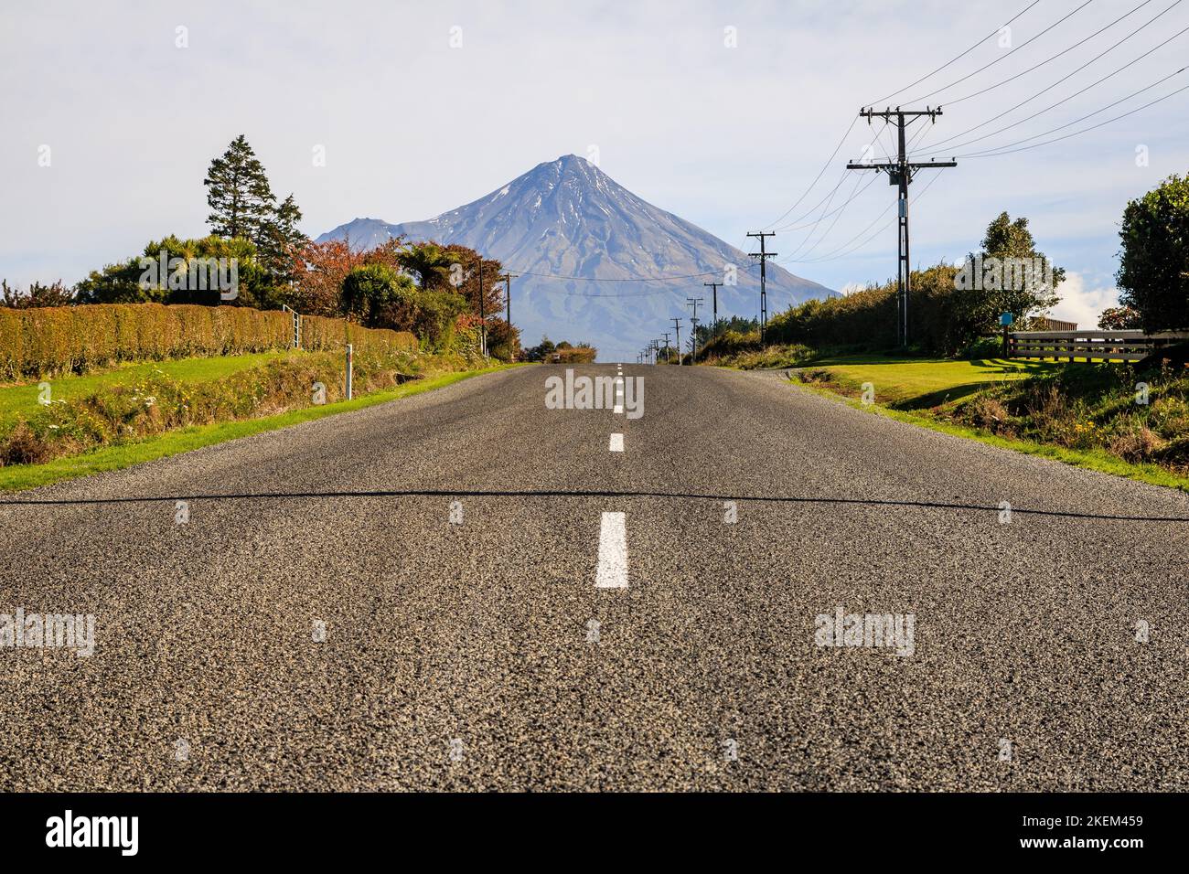 A scenic view of an open road surrounded by greenery with Taranaki ...