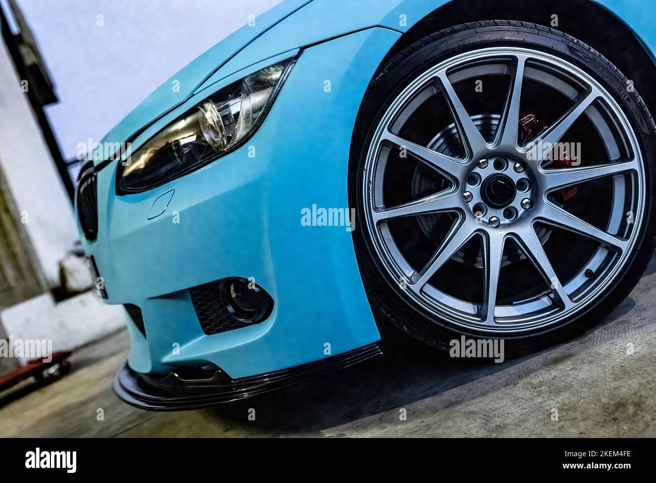 Close up of headlight and car wheel with custom disk of tuned low rider ...