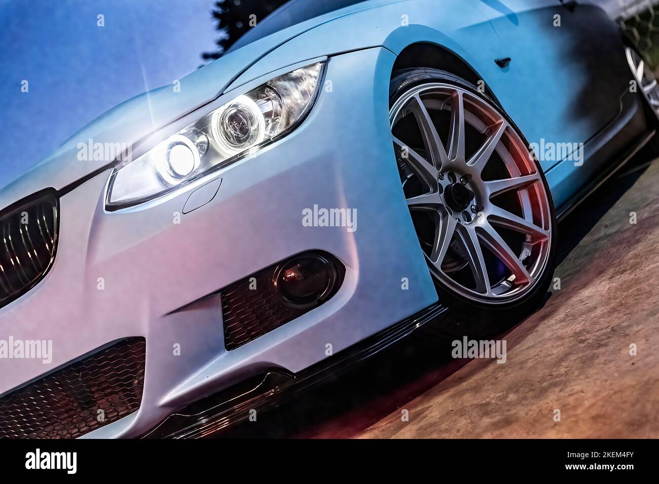 Close up of headlight and car wheel with custom disk of tuned low rider ...
