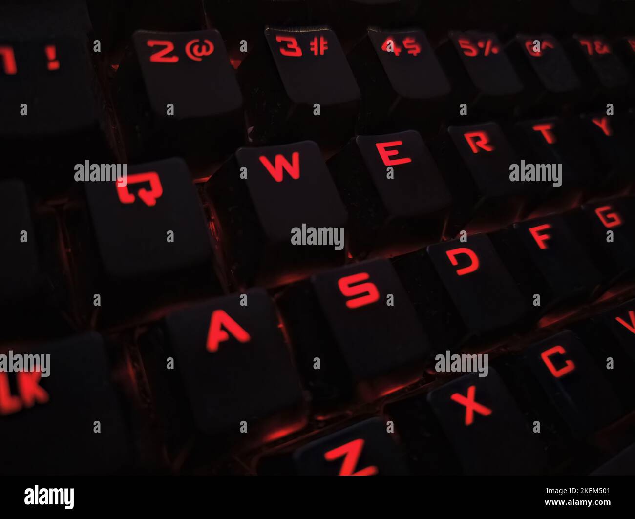 Backlit keyboard close up. Black keys with illuminated characters ...