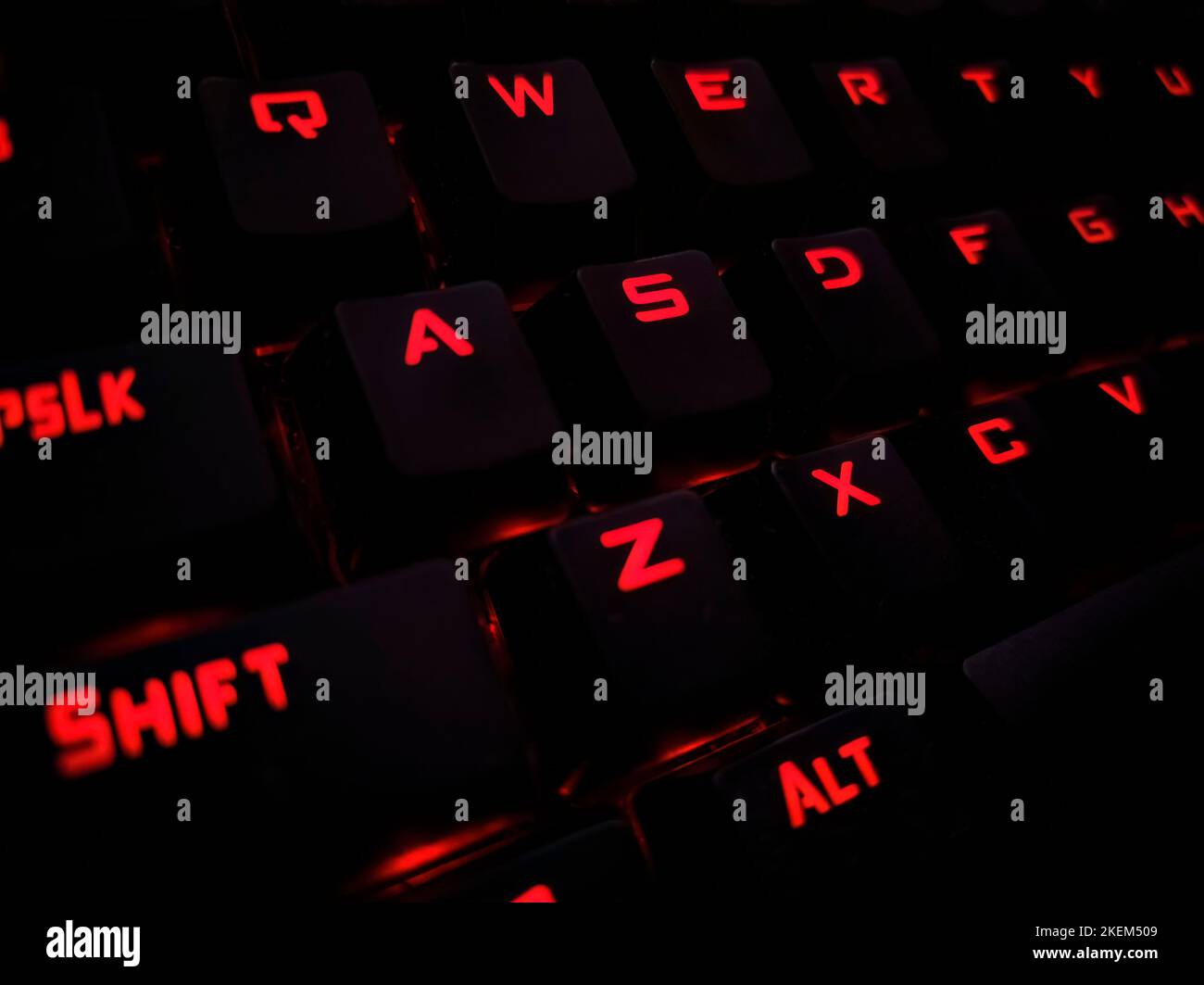 Backlit keyboard close up. Black keys with illuminated characters ...