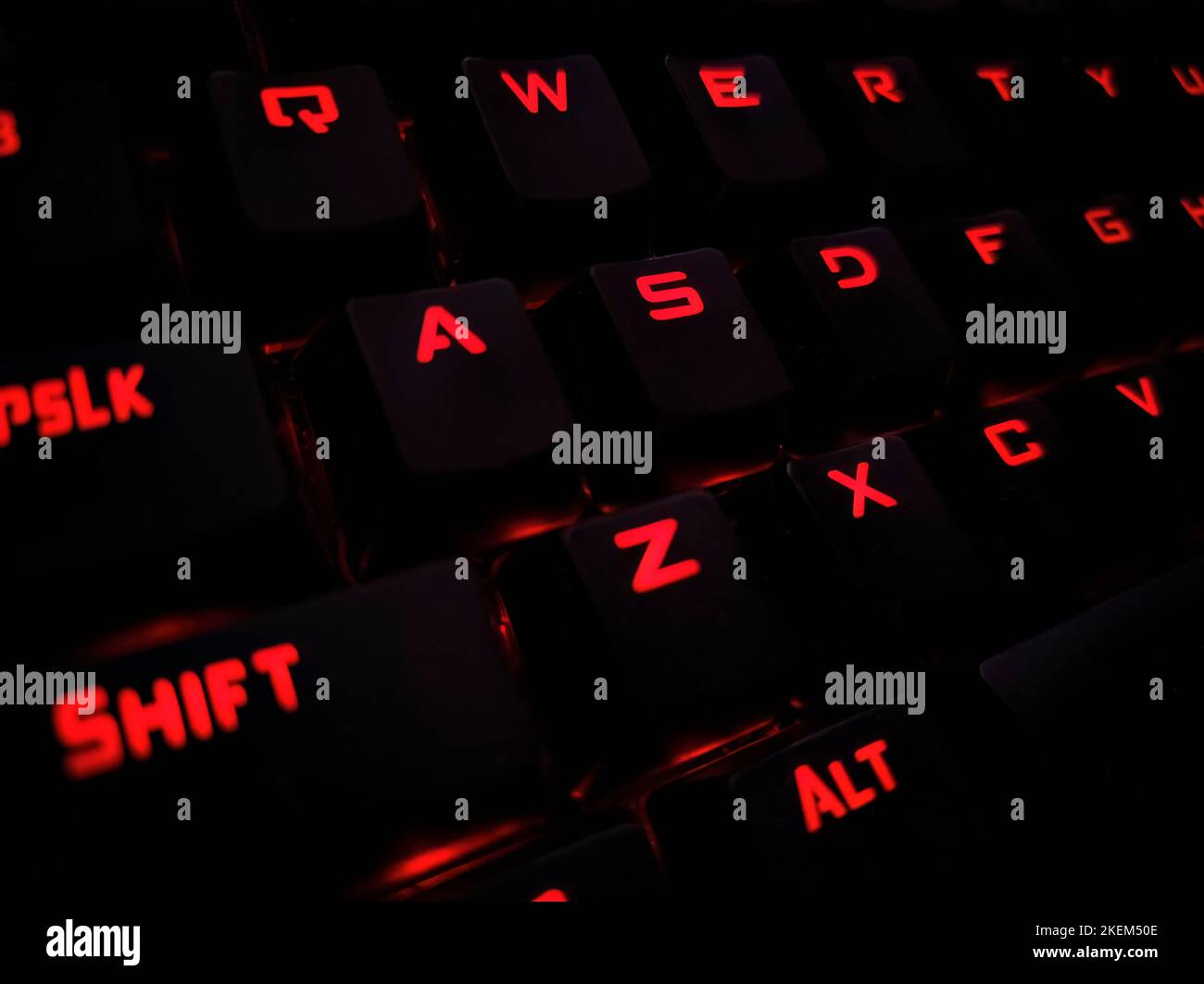 Backlit keyboard close up. Black keys with illuminated characters ...