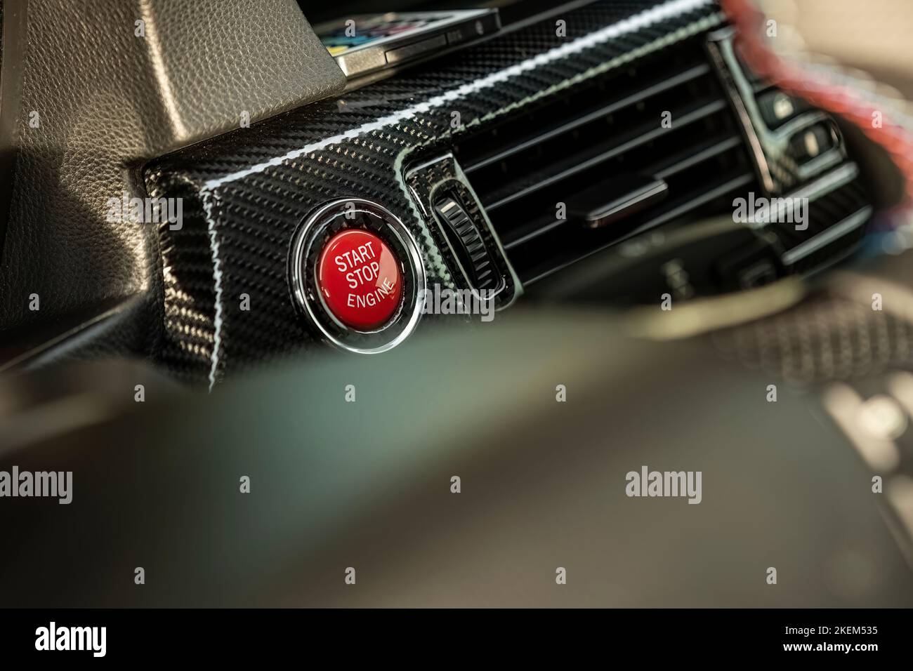 Red engine start button detail. Car dashboard with focus on red engine ...