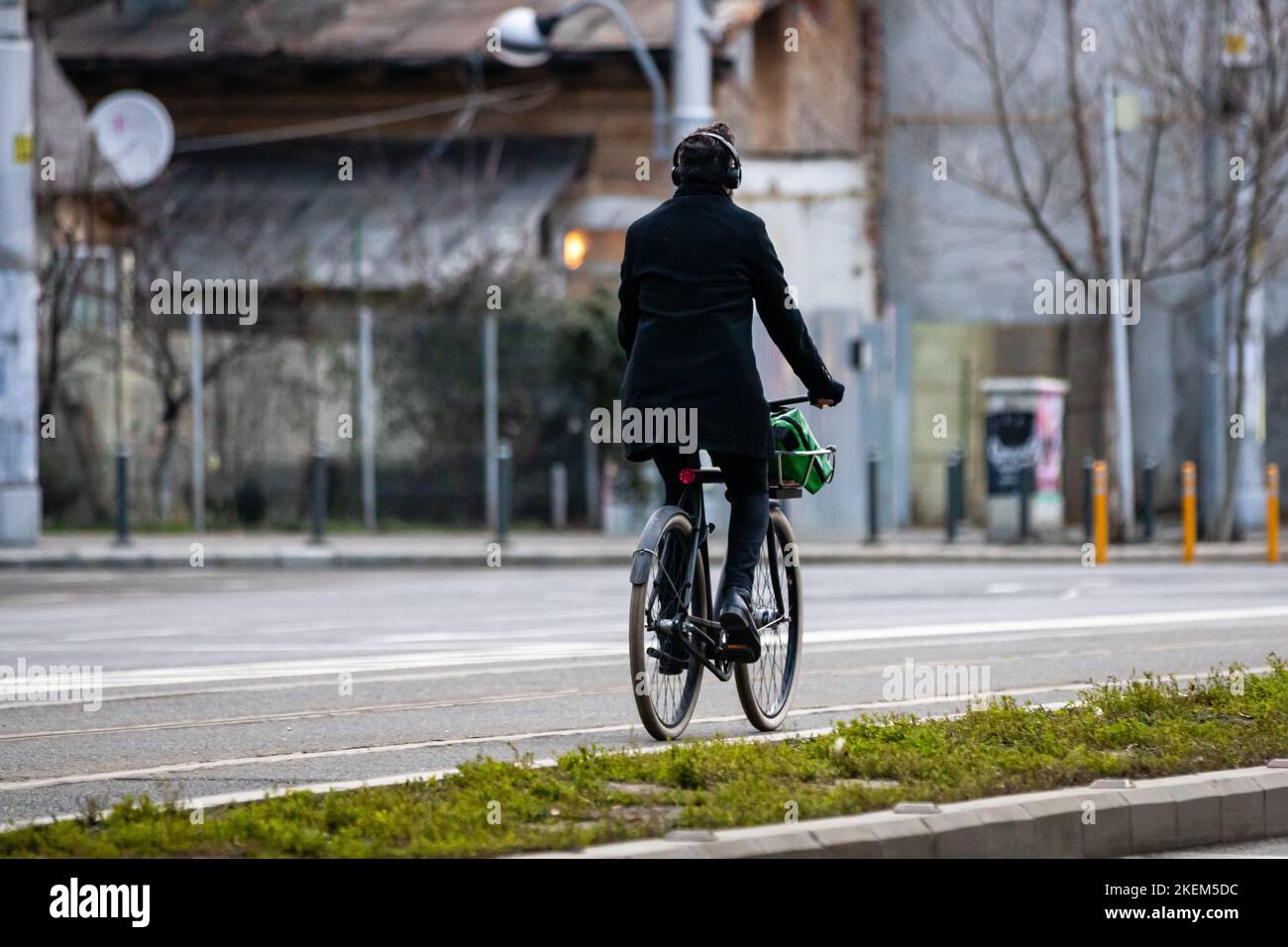 Riding a bicycle on the city streets. Commute to work in Bucharest ...