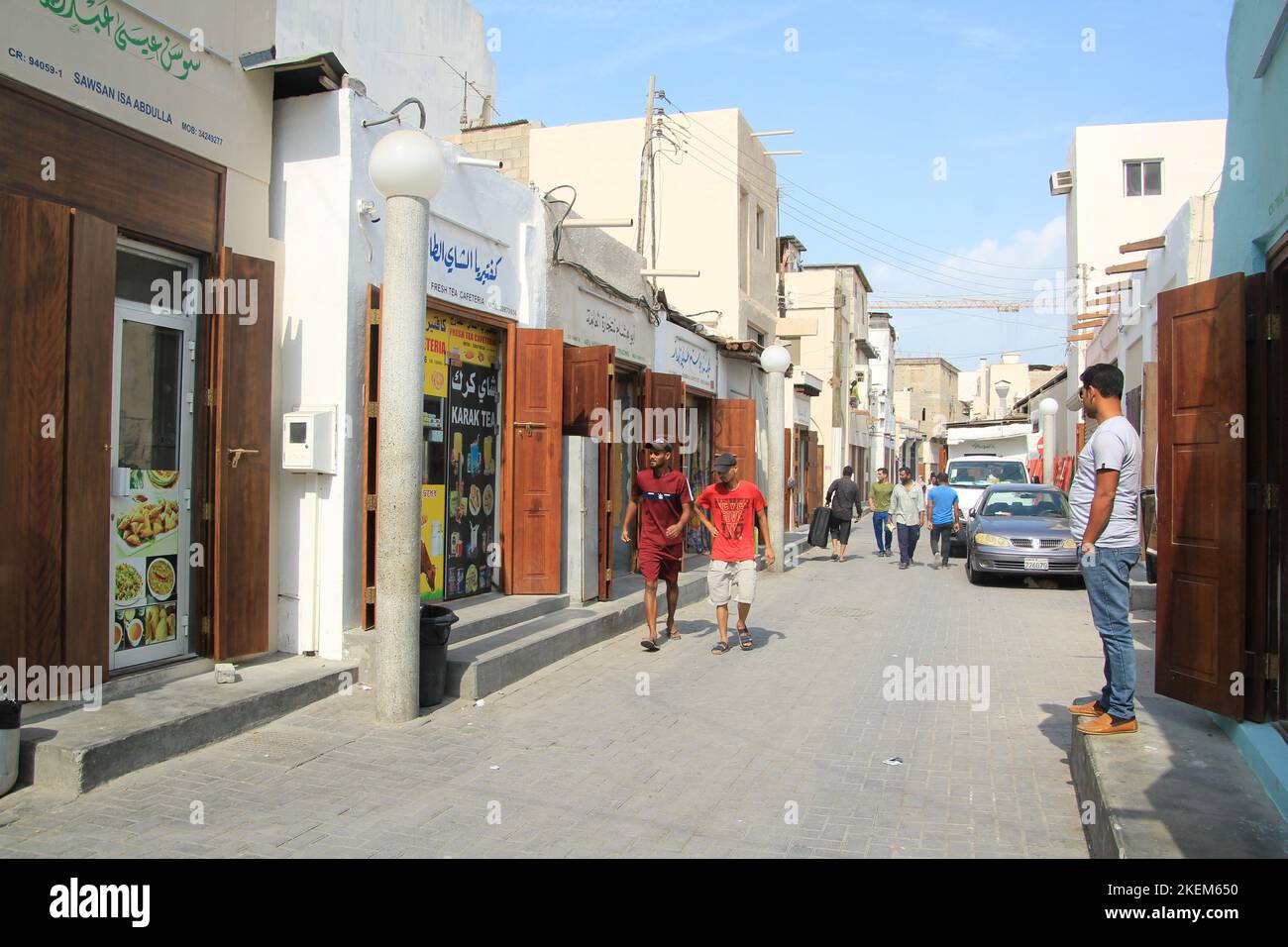 Muharrak, Bahrain. 07th Nov, 2022. Passers-by walk past stores. Credit ...