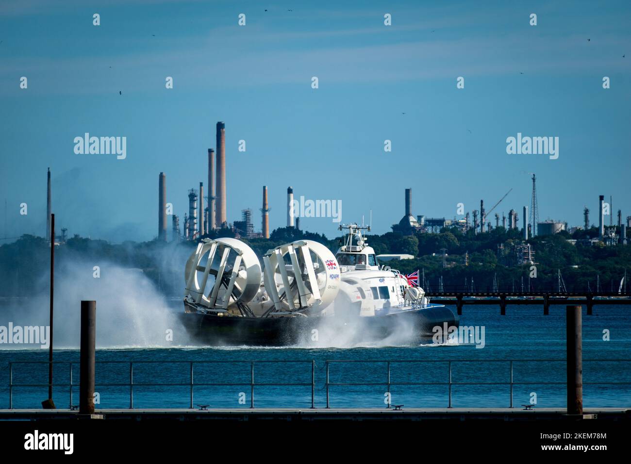 A hovercraft flying down the Itchen River with Esso Refinery in the ...