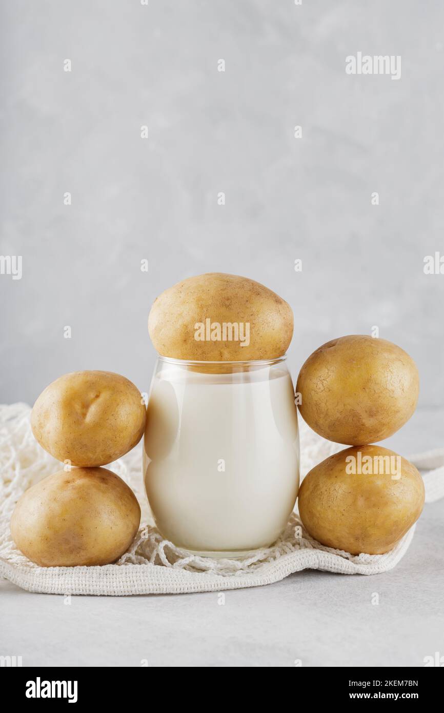 Alternative potato milk in glass and potatoes. Alternative non dairy ...