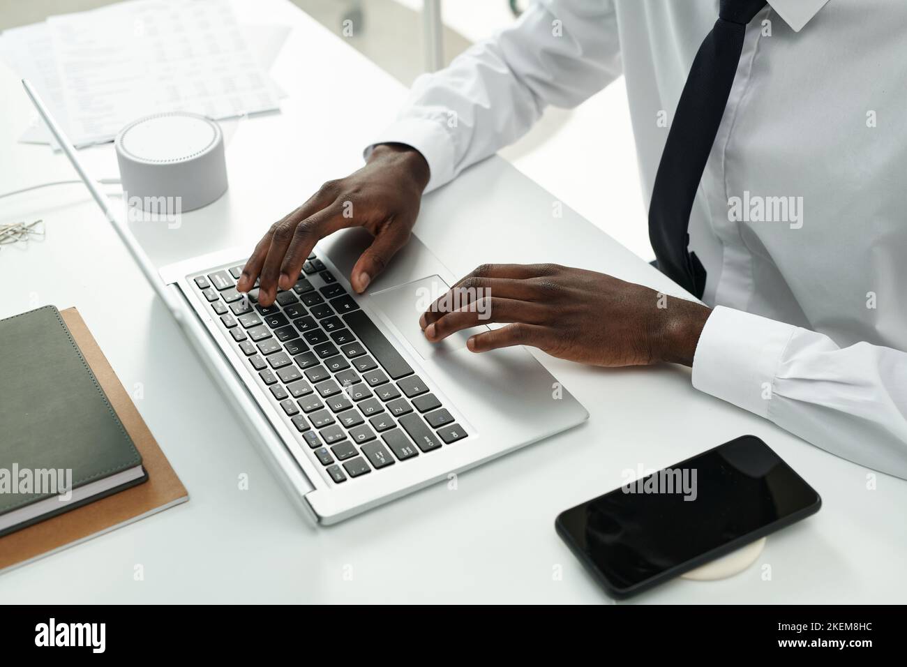 High angle view of African American businessman sitting at table and ...