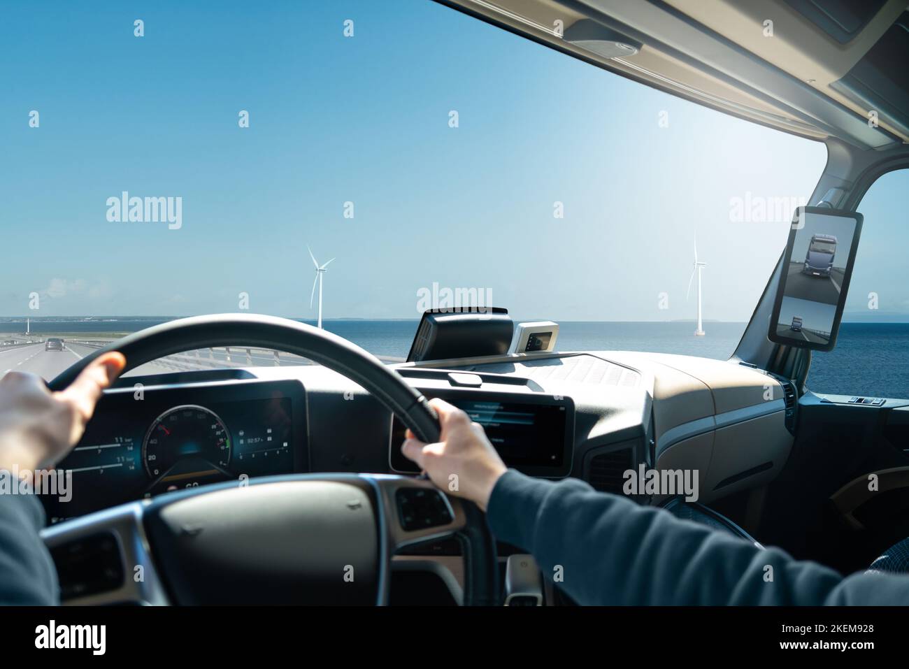 Trucker drives a modern truck across the bridge. View from the cabin to ...