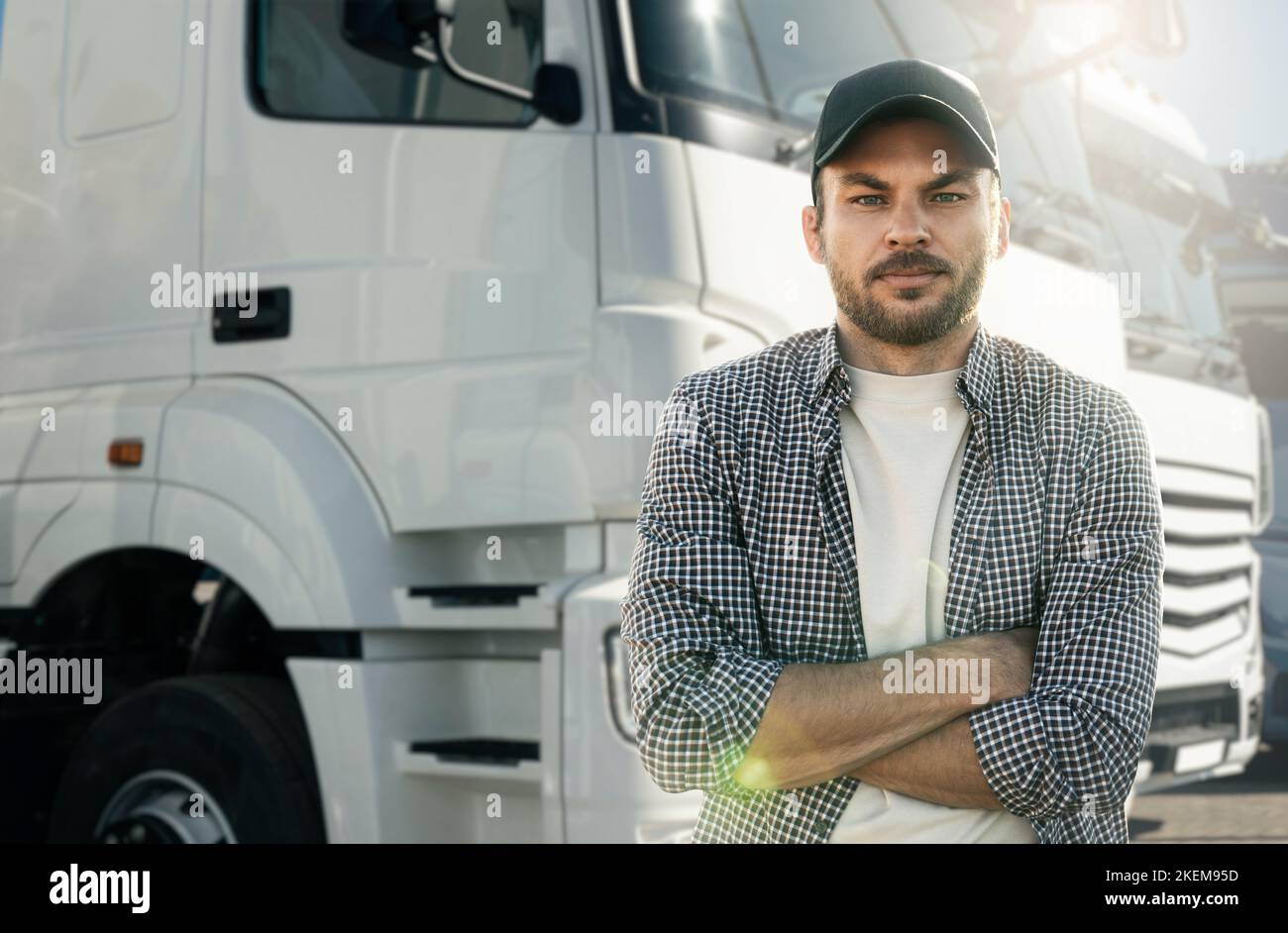 Truck driver standing in front of trucks Stock Photo - Alamy
