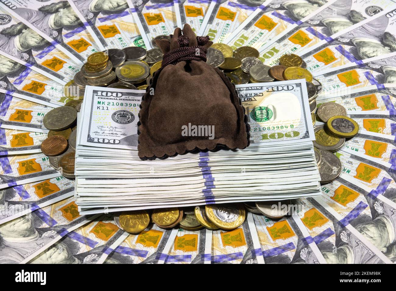 A money sack and a stack of American dollar bills on a pile of ...