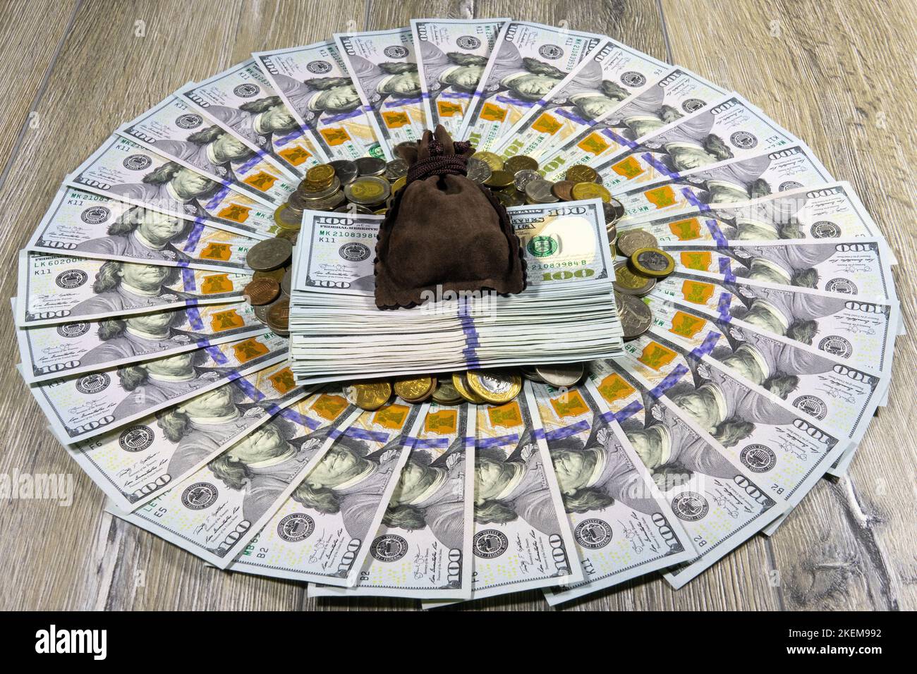 A money sack and a stack of American dollar bills on a pile of ...