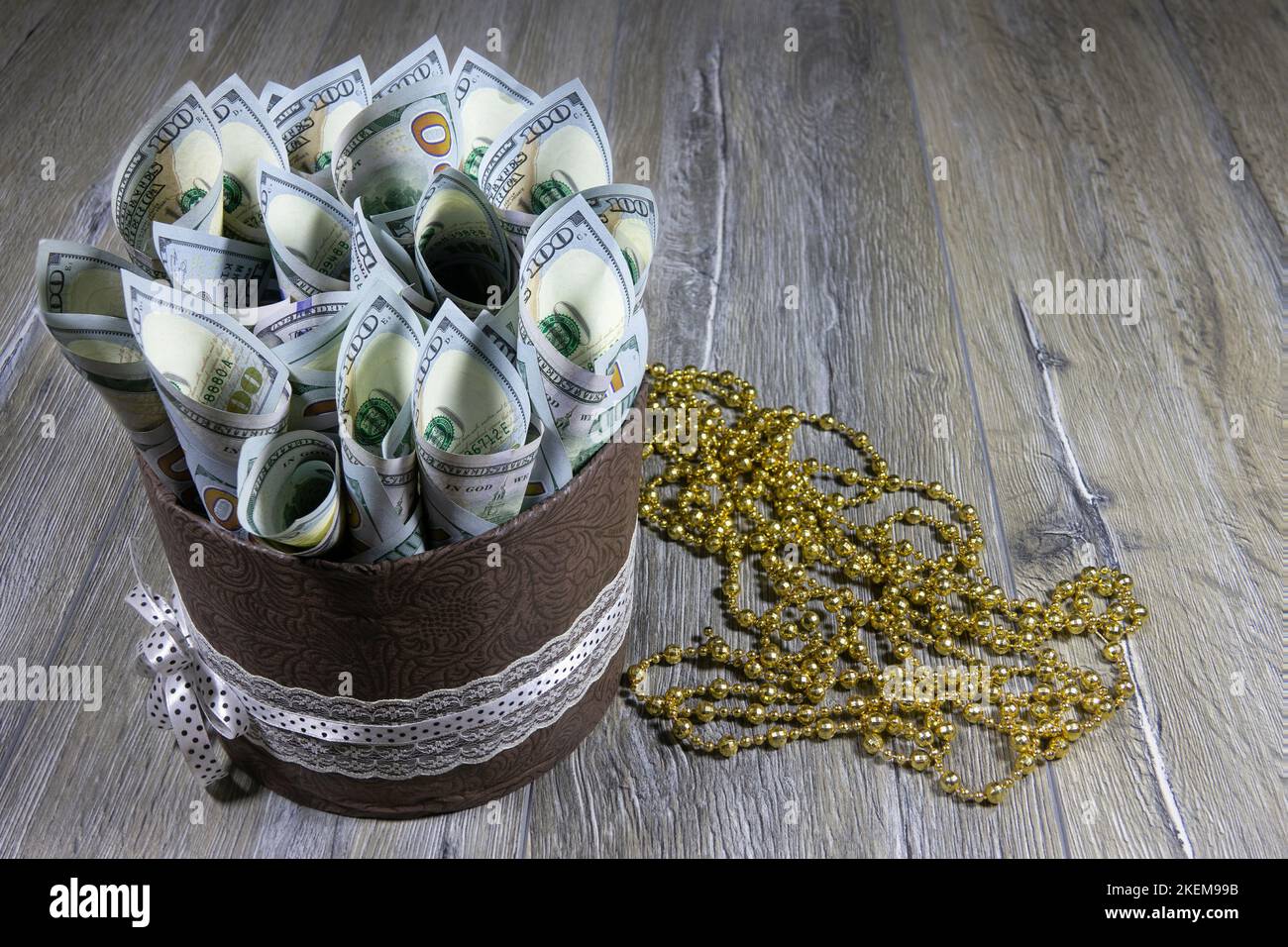 Gift box in the form of a cylinder with one hundred dollar bills of ...