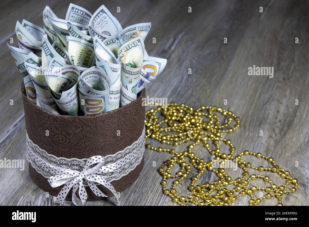 Gift box in the form of a cylinder with one hundred dollar bills of ...