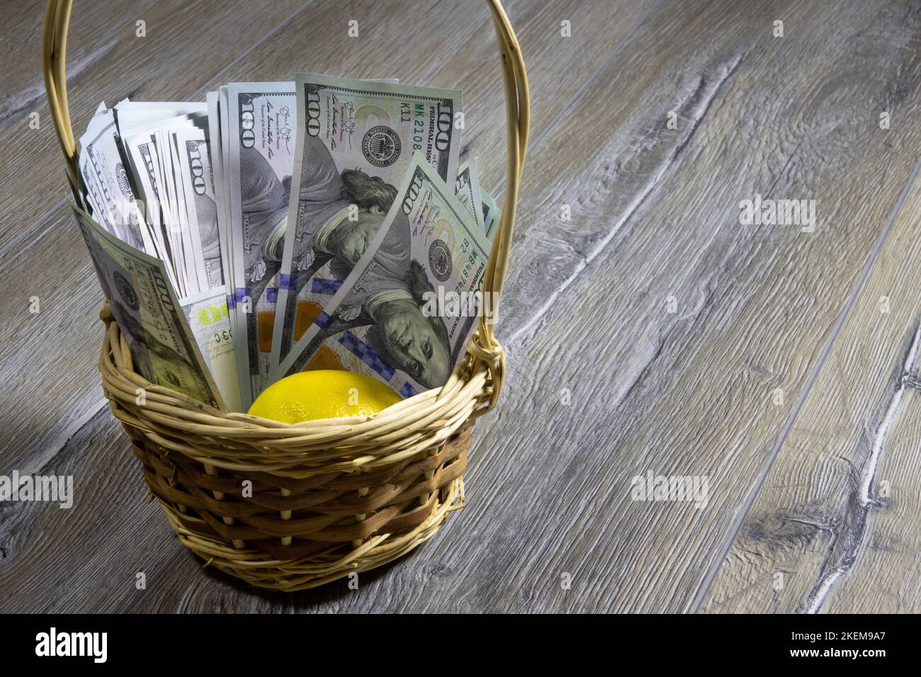 Wicker basket with one hundred dollar banknotes of American dollars and ...