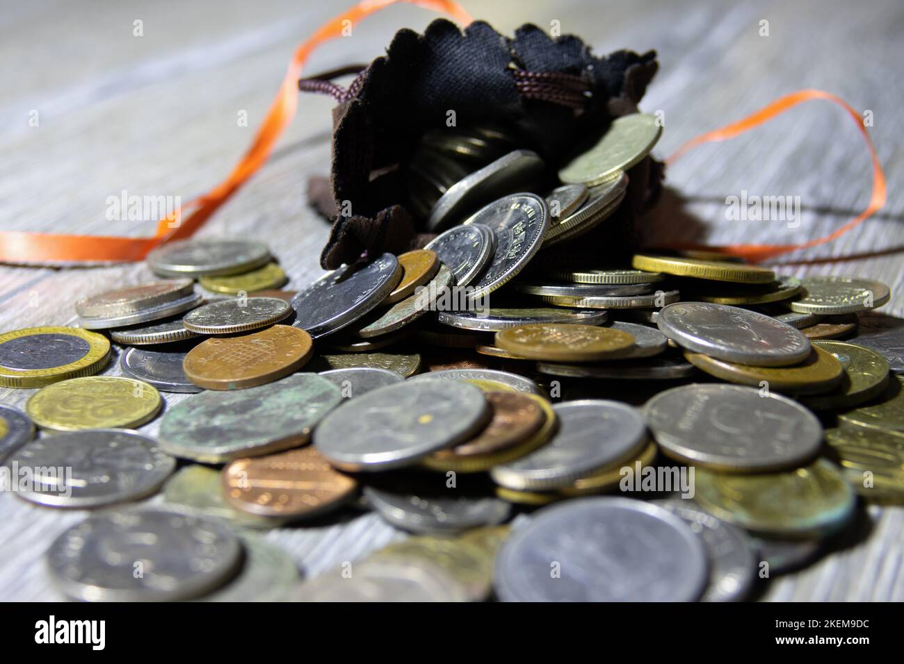 Closeup of a money sack with different coins of the world. Banking and ...