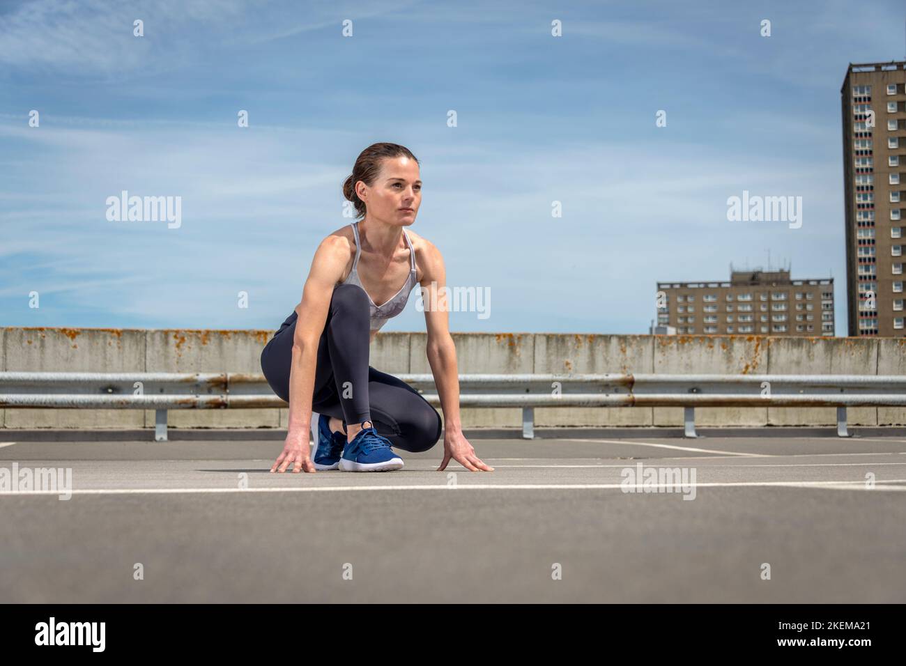 Woman working out outdoors. Lady doing exercises and ready to start ...