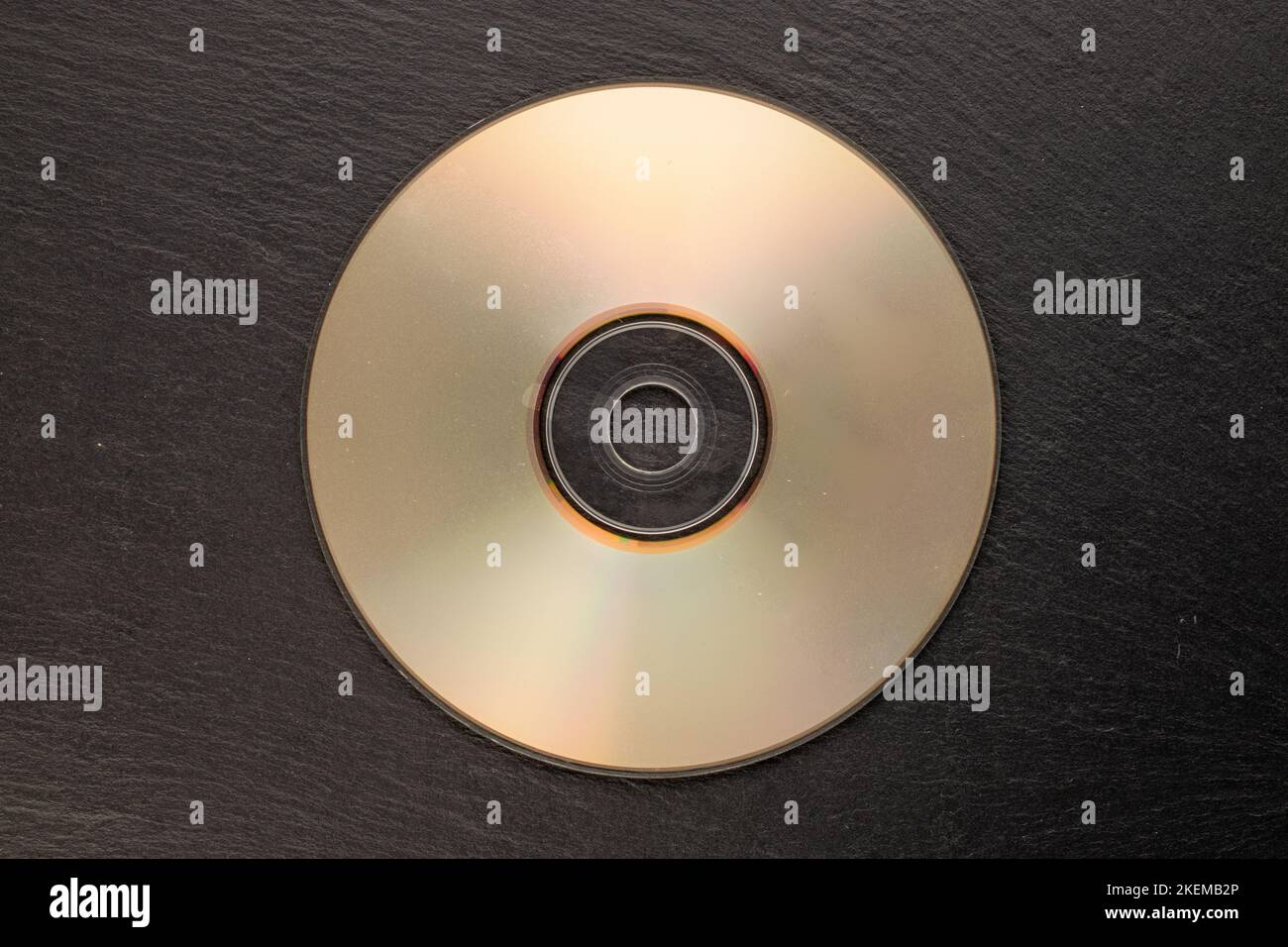One CD-R disc on slate stone, macro, top view Stock Photo - Alamy