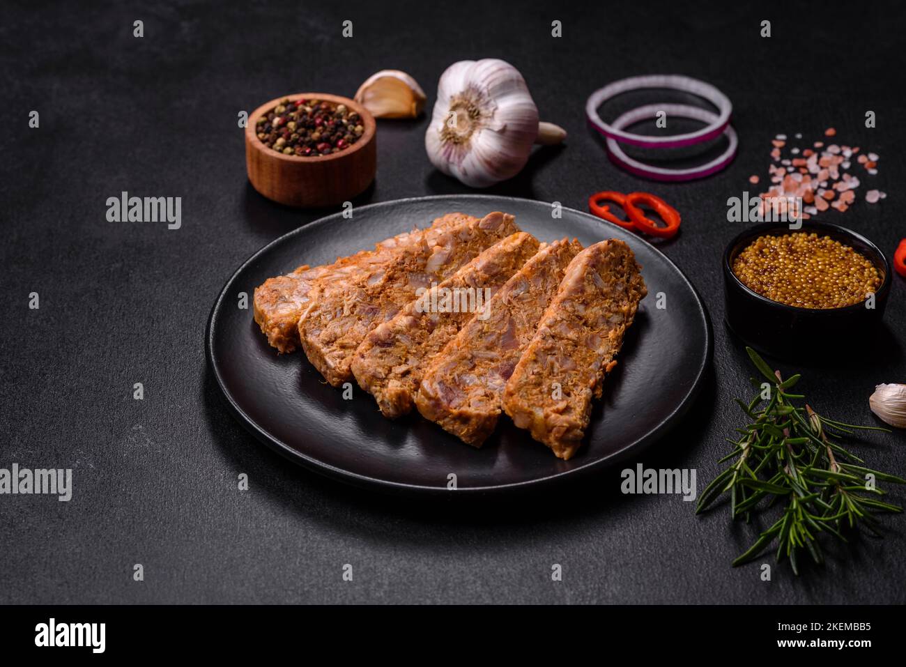 Tasty meat brawn or roll on a wooden cutting board with spices and ...