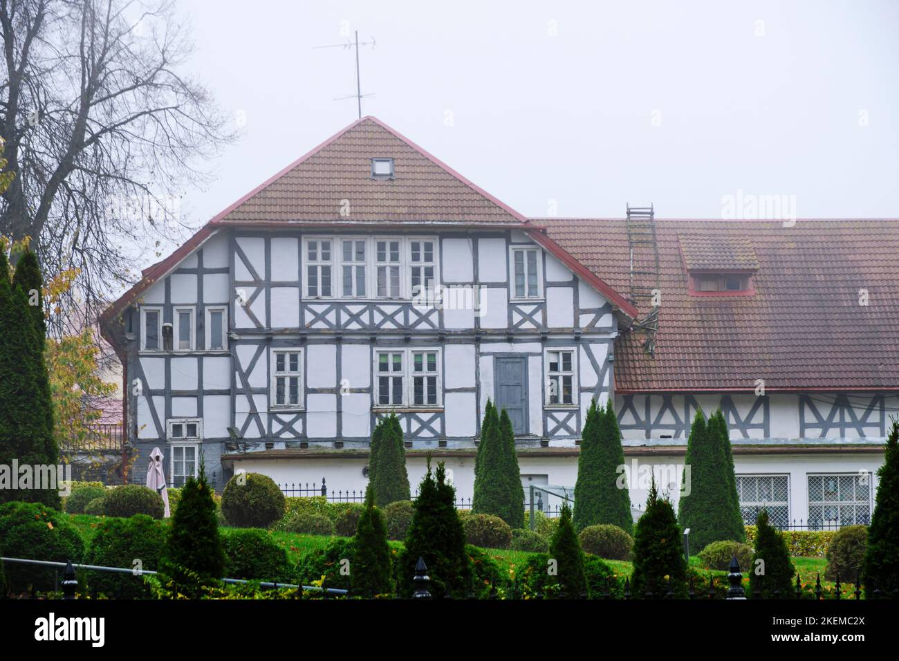 Old retro house with red tiled roof Prussian style with green spaces in ...