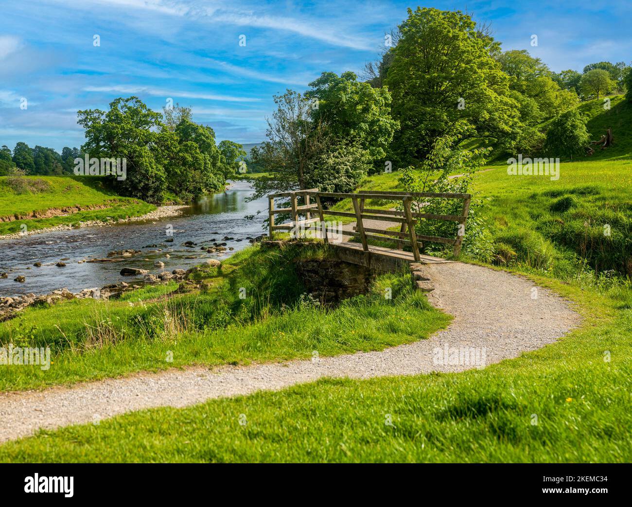 Landscape of footpath and footbridge alongside the River Wharfe on The ...