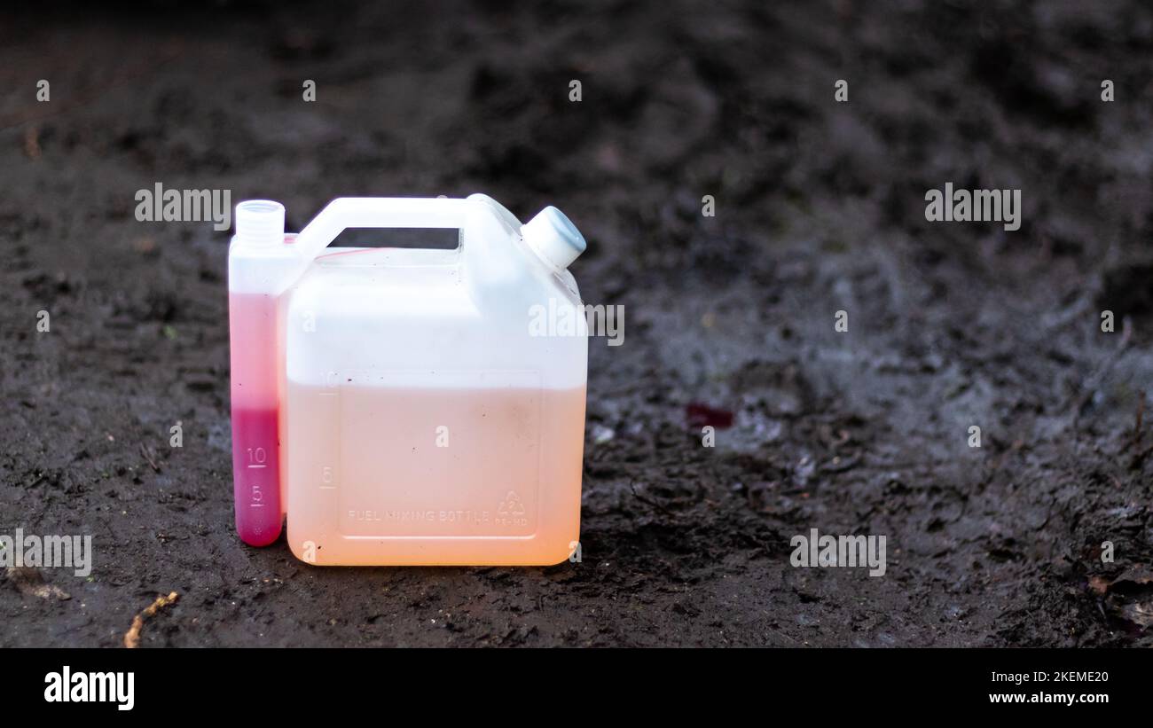 Fuel mixing can or bottle on the ground for two stroke machines Stock ...