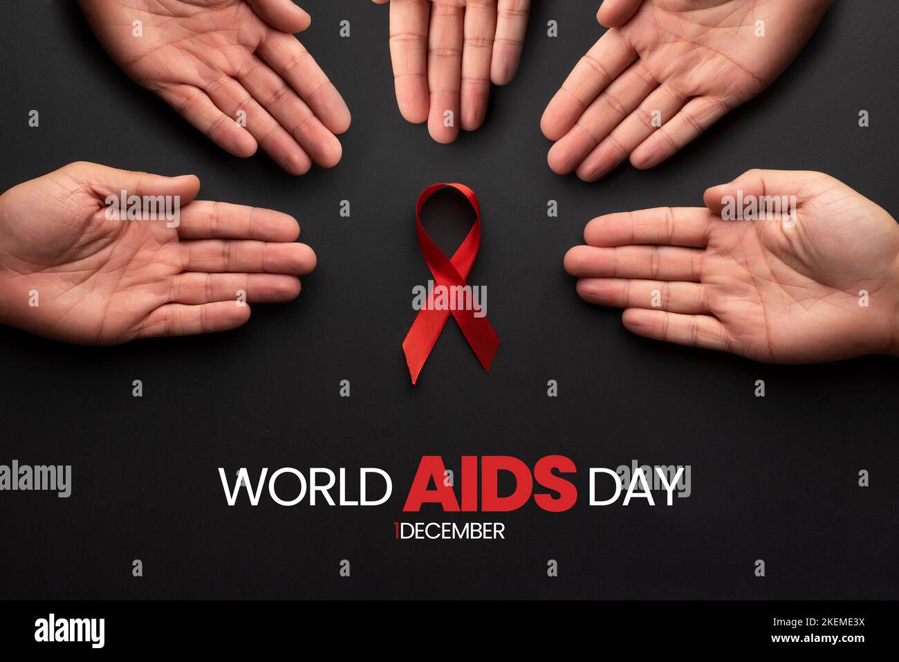 Set of hands encircling a red ribbon symbolizing World AIDS Day. December 1st, day of the fight ...