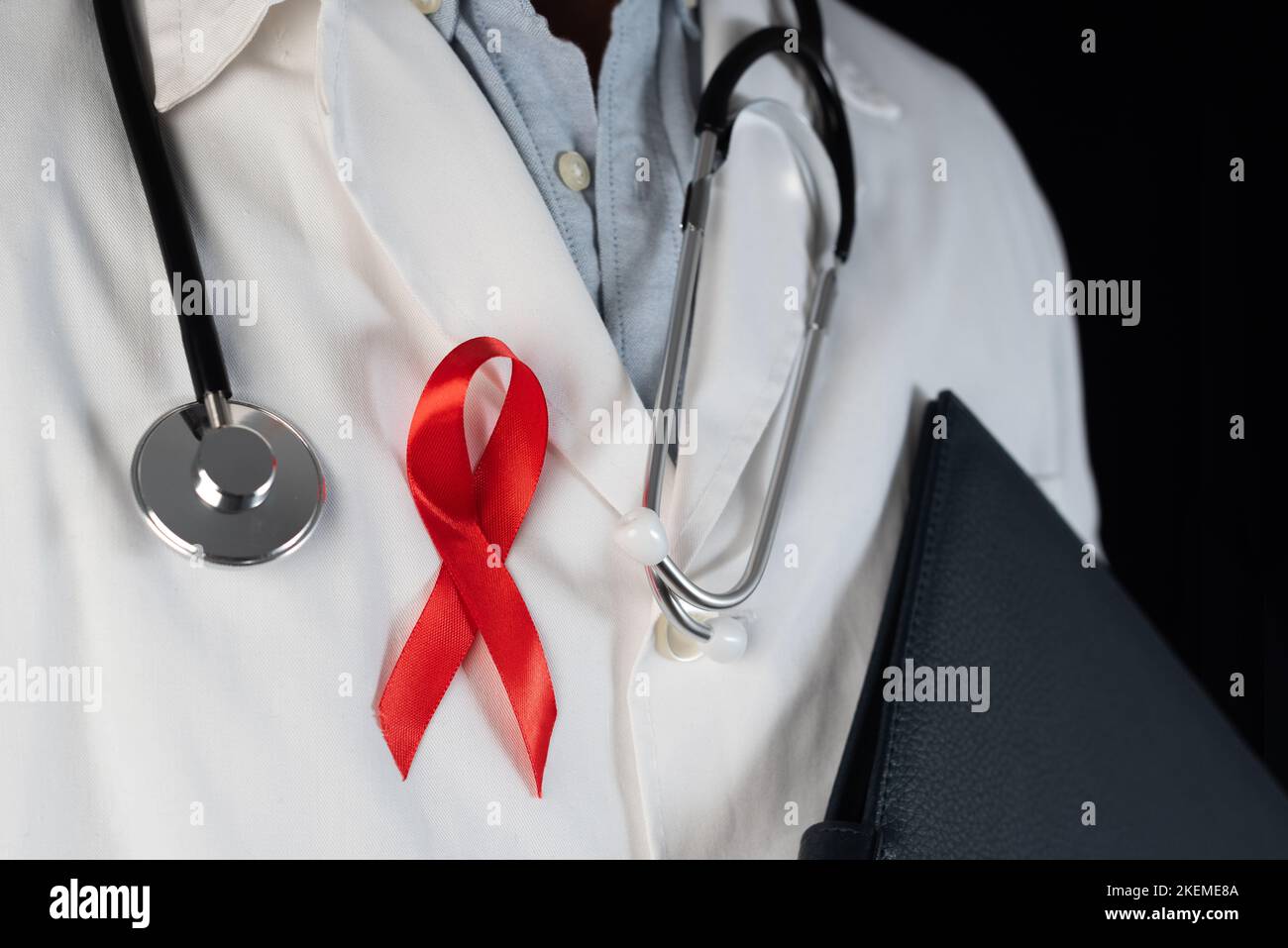 Close-up of a doctor wearing a red ribbon on his chest, symbol of World ...